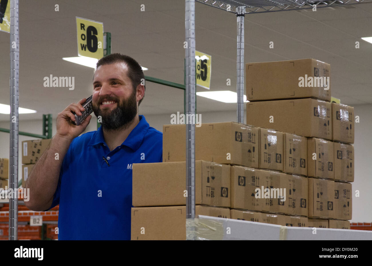 employee talking on phone while working in warehouse with boxes Stock ...