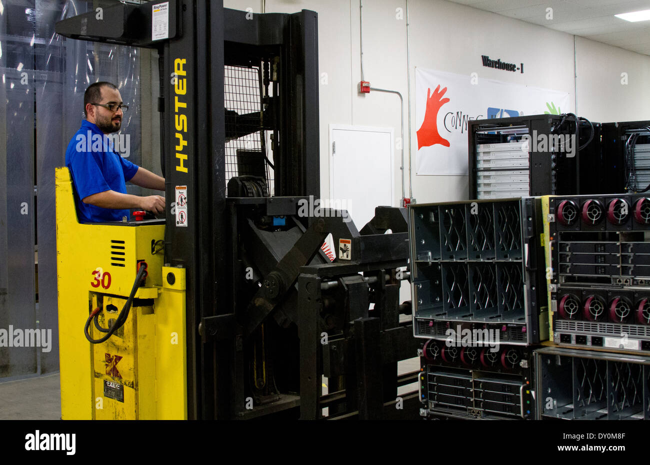 employee working on forklift inside computer technology warehouse Stock ...