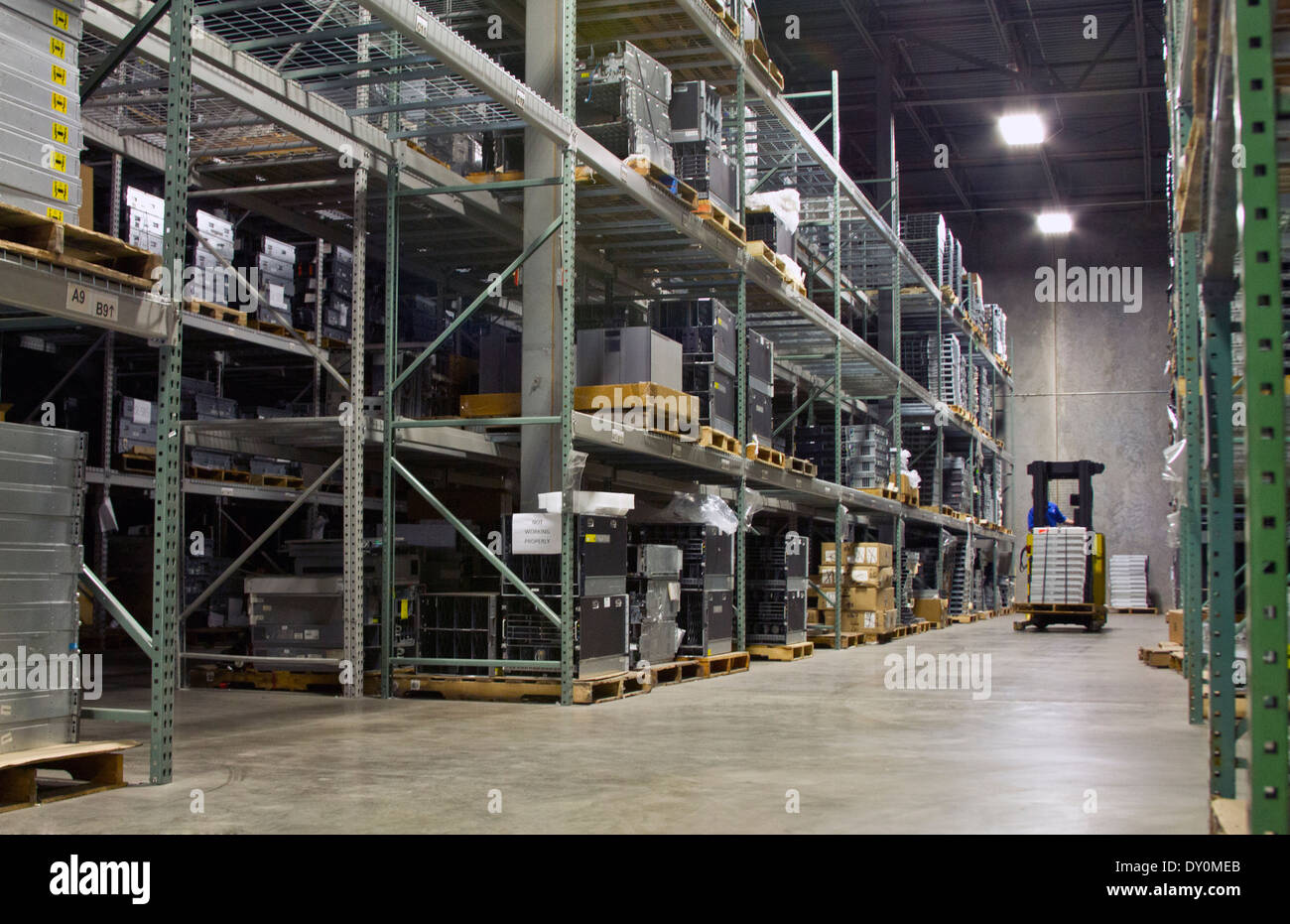 employee working on forklift inside computer technology warehouse Stock ...