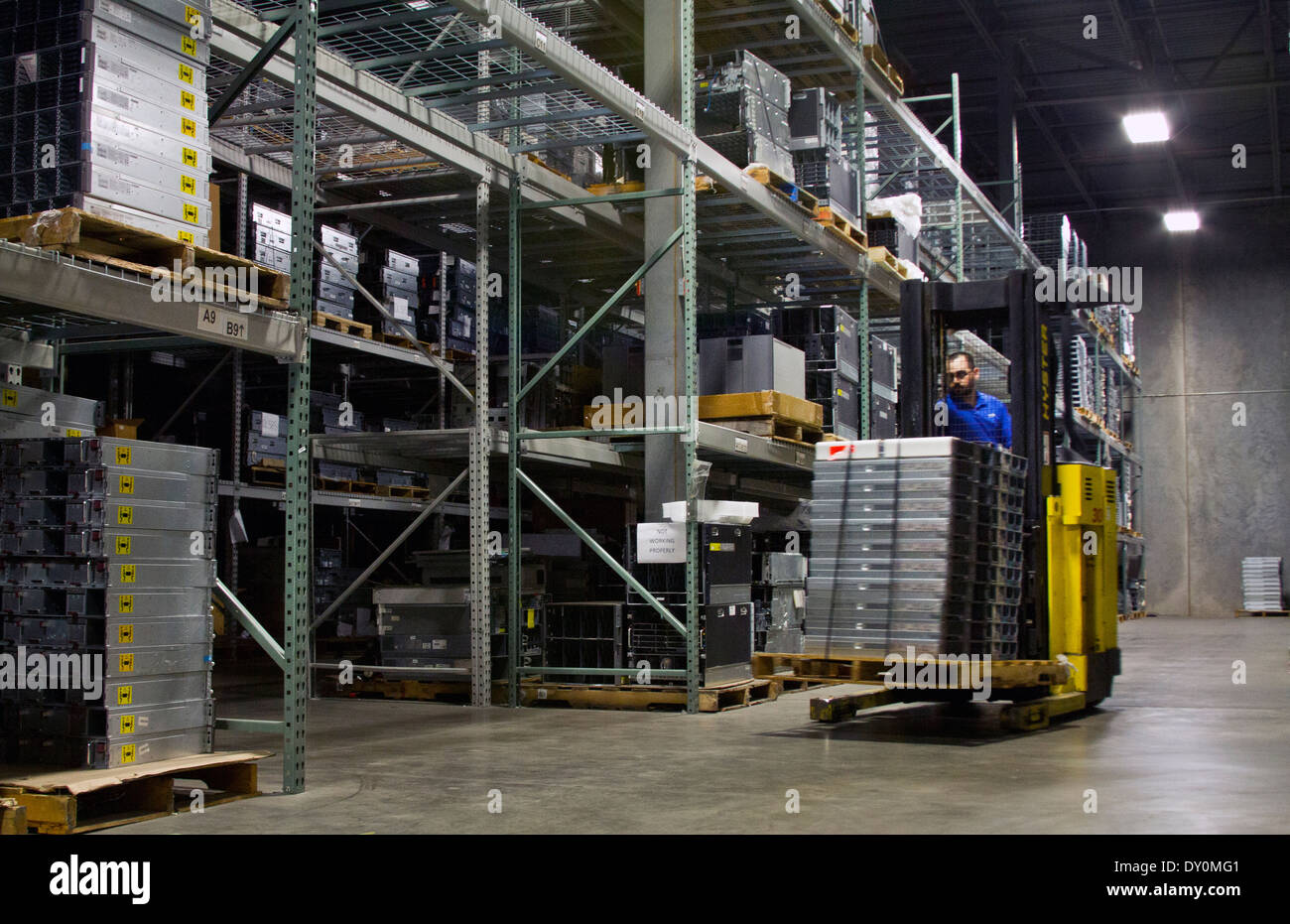 employee working on forklift inside computer technology warehouse Stock ...
