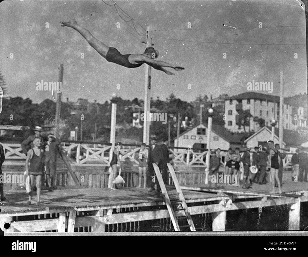 A 1935 photograph by Sam Hood showing a young diver in mid-air as he ...