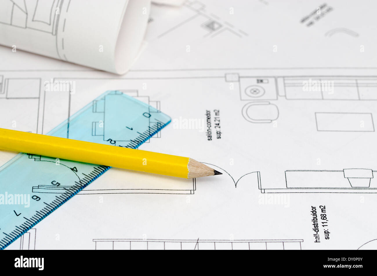 A floor plan with yellow pencil and ruler on the left side of the image ...