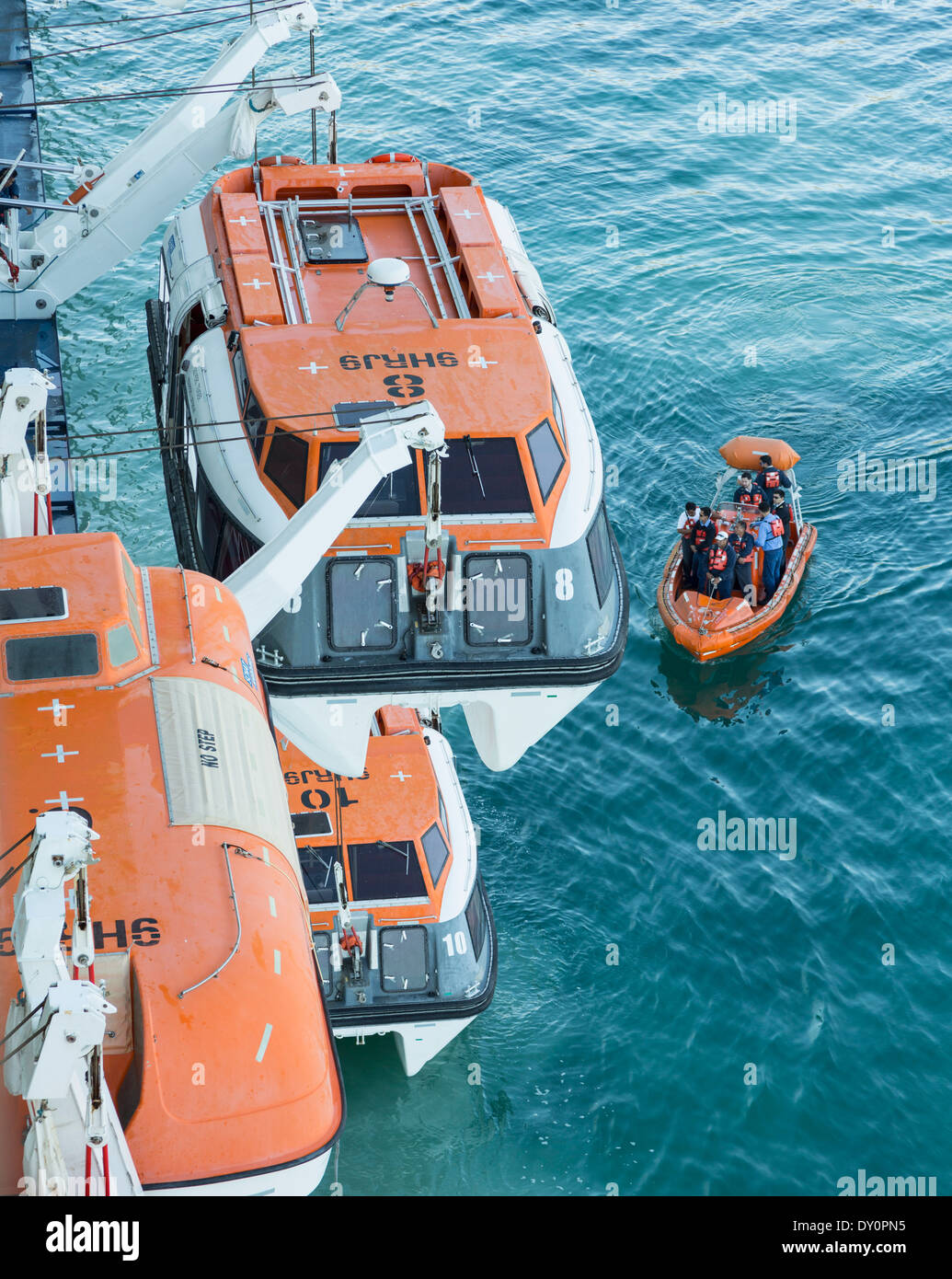 Life boat being lowered into the sea from a cruise ship Stock Photo - Alamy
