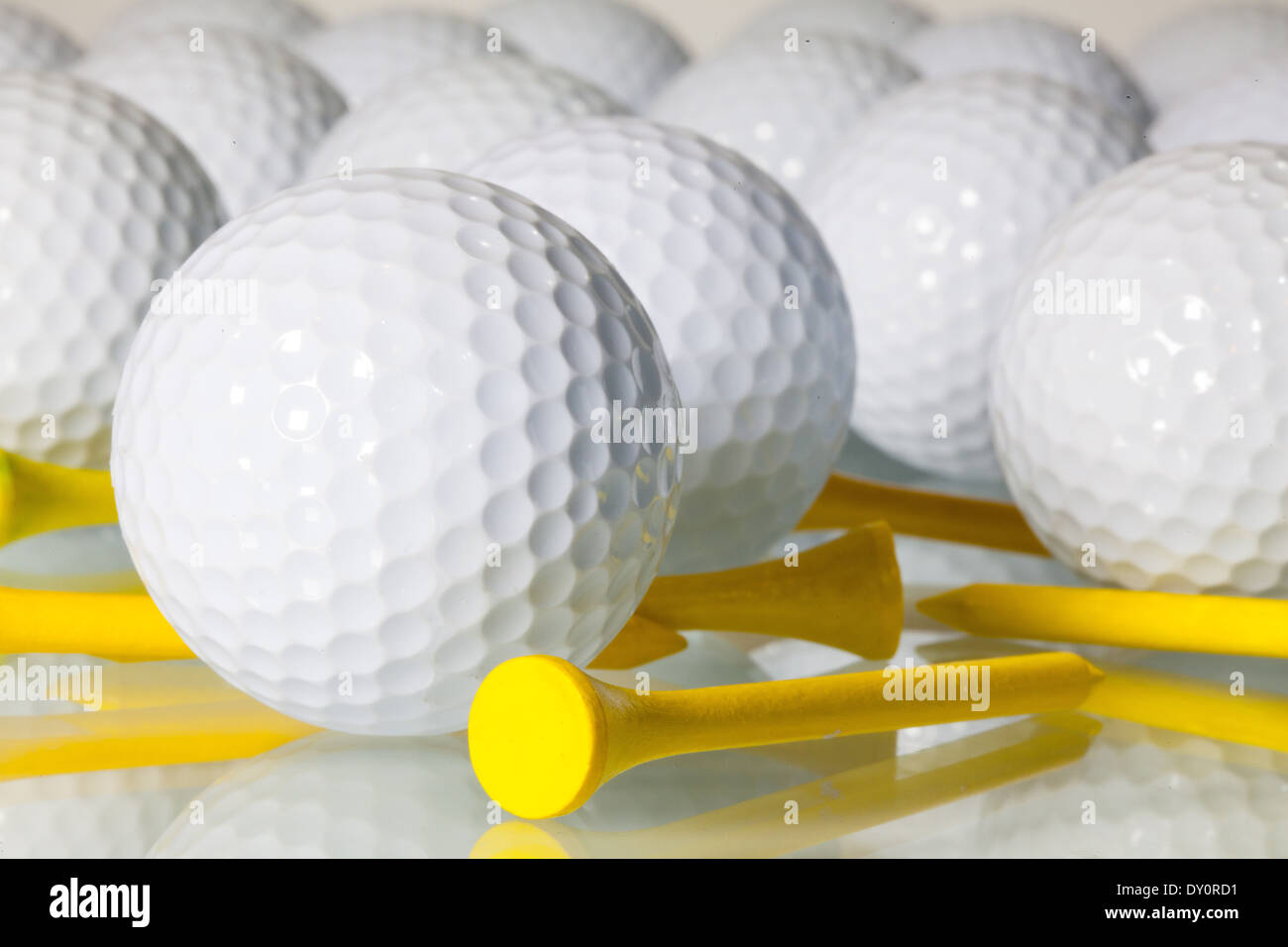 Different golf balls on a glass table Stock Photo - Alamy