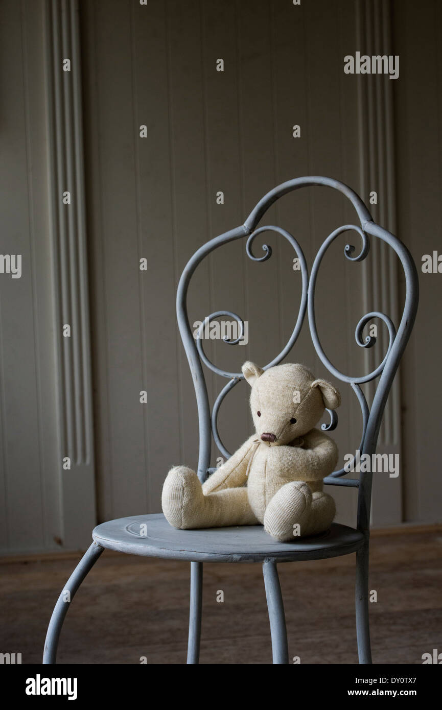 Thoughtful Teddy bear sat on a seat in a garden summer house Stock ...