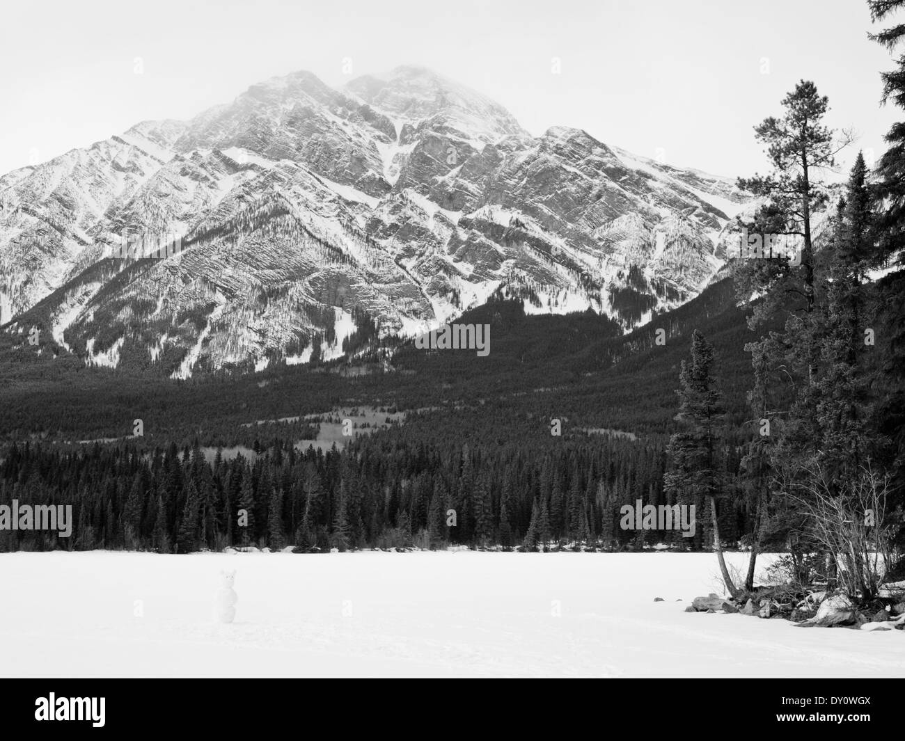 A black-and-white photo of Pyramid Mountain and frozen Pyramid Lake in ...