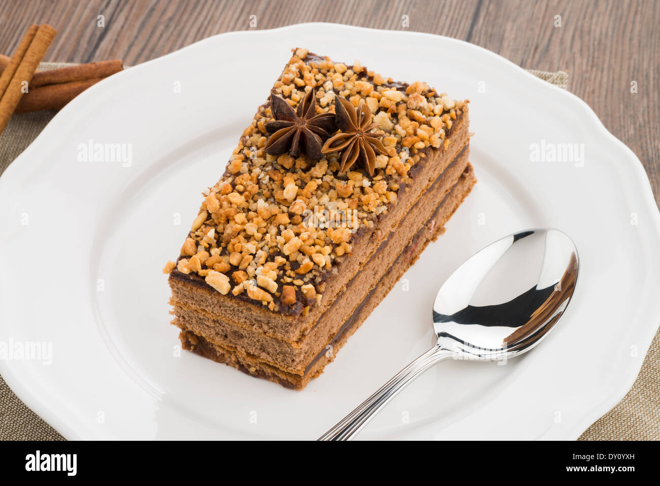 Chocolate cake on white plate over wooden table Stock Photo - Alamy