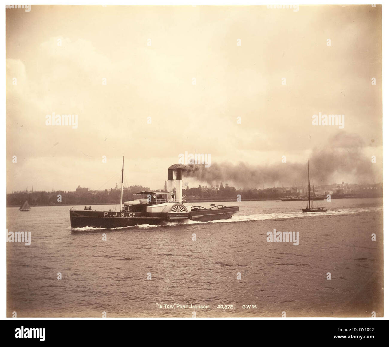This historical photograph shows the steam-boat Commodore in tow in ...