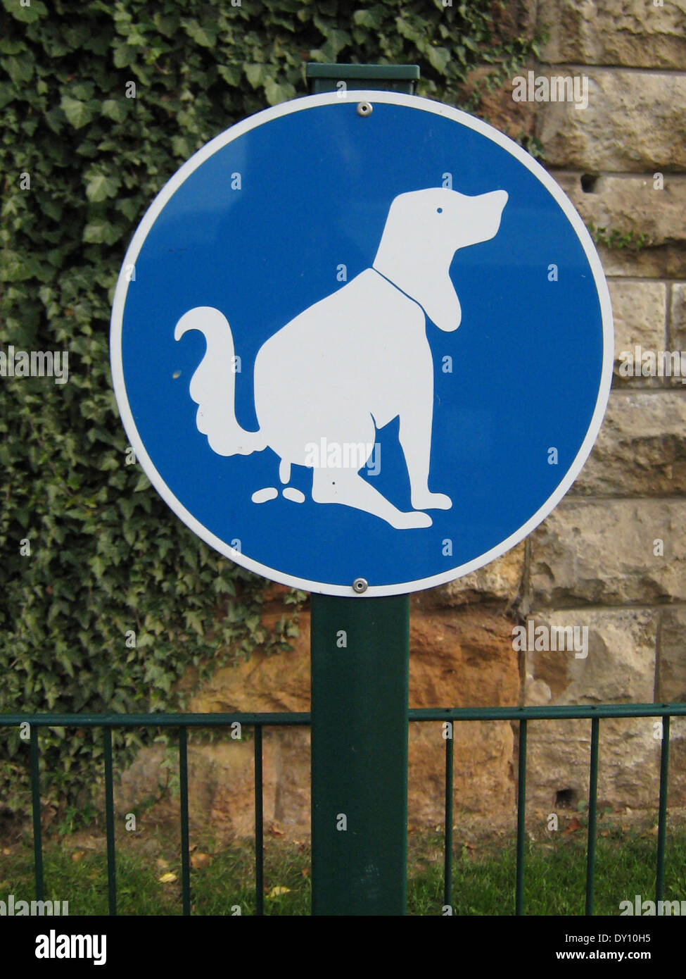 Information sign at a public dog toilet. It is showing a dog doing his ...
