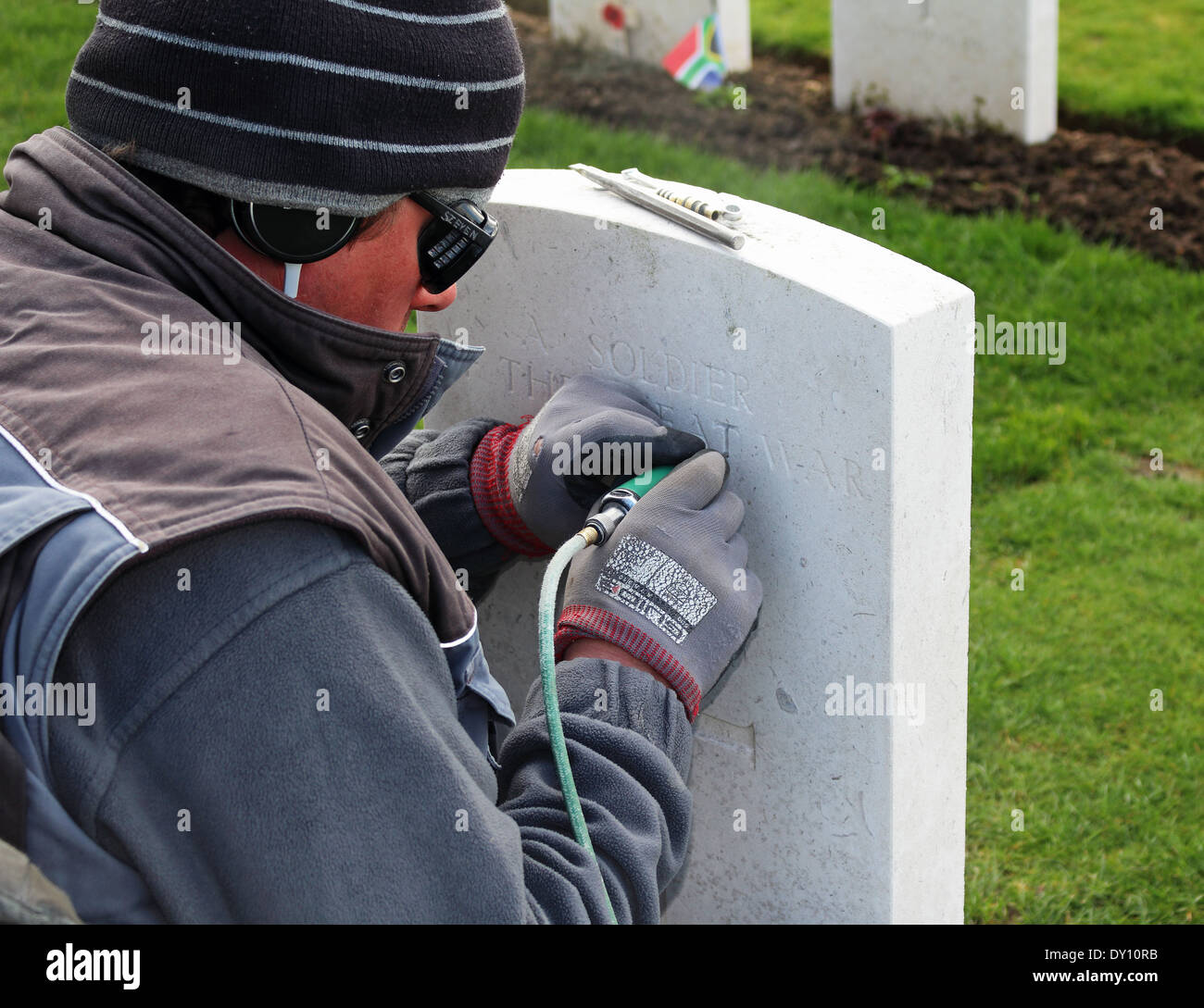Workman engraving a World War 1 Soldiers Headstone in a War Cemetery in ...