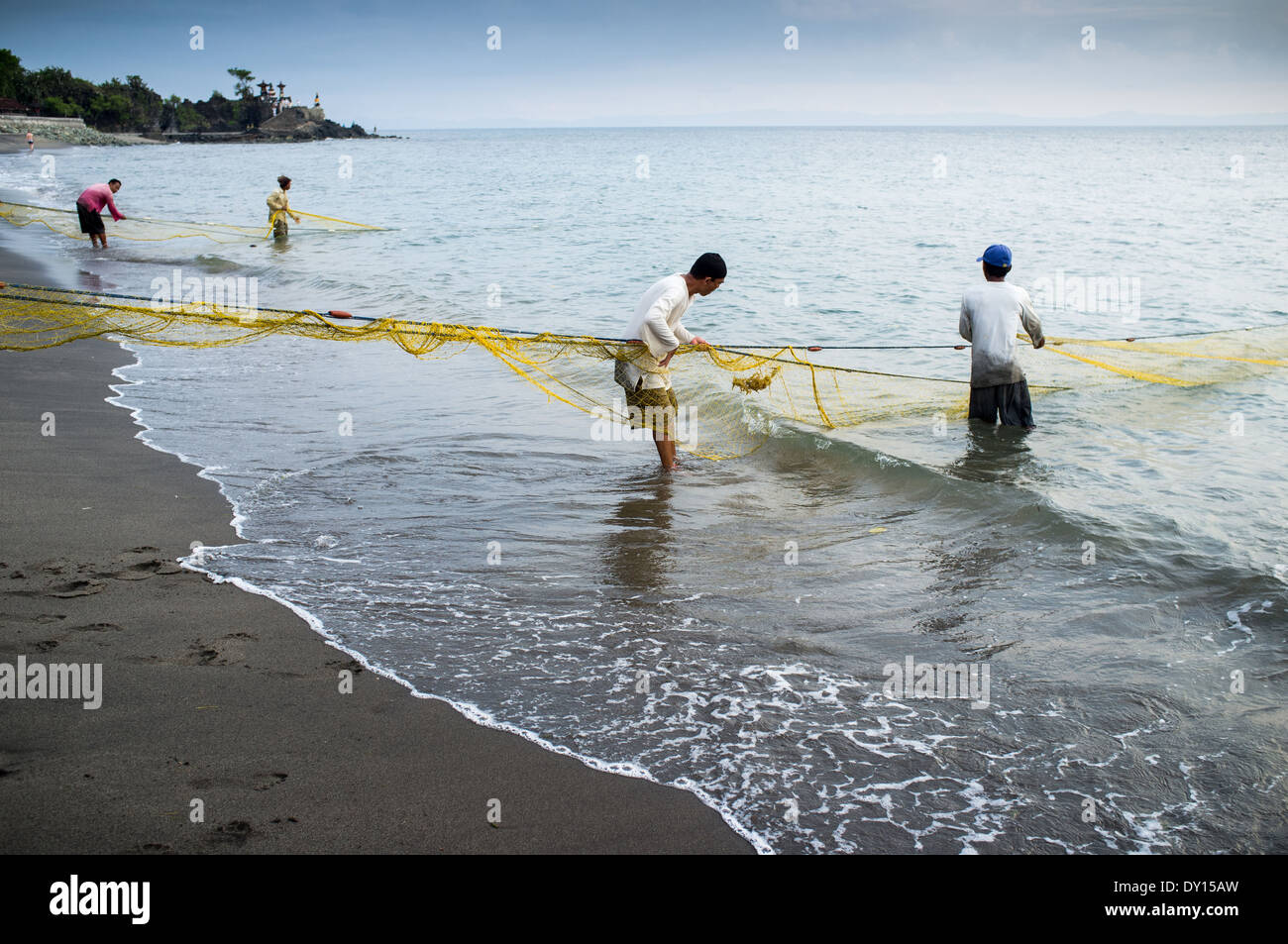 Local Fisherman netting fish on Senggigi Beach in Lombok island ...