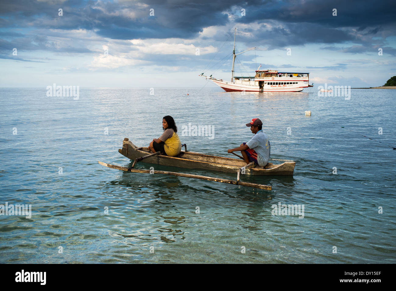 local people on the fishing boat, in background boat of Peramatour ...
