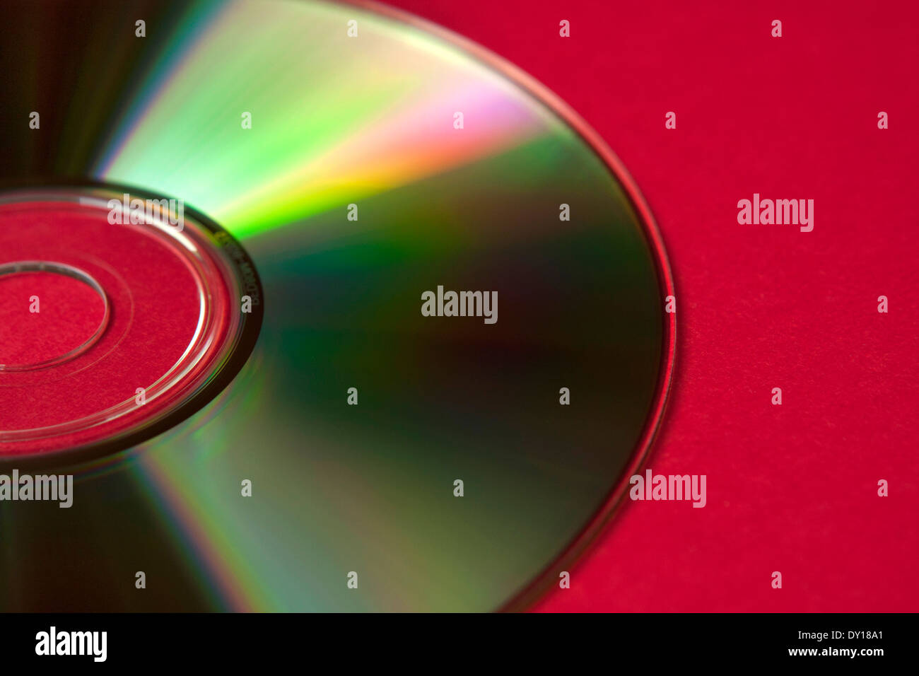 blank media disc on red background Stock Photo - Alamy