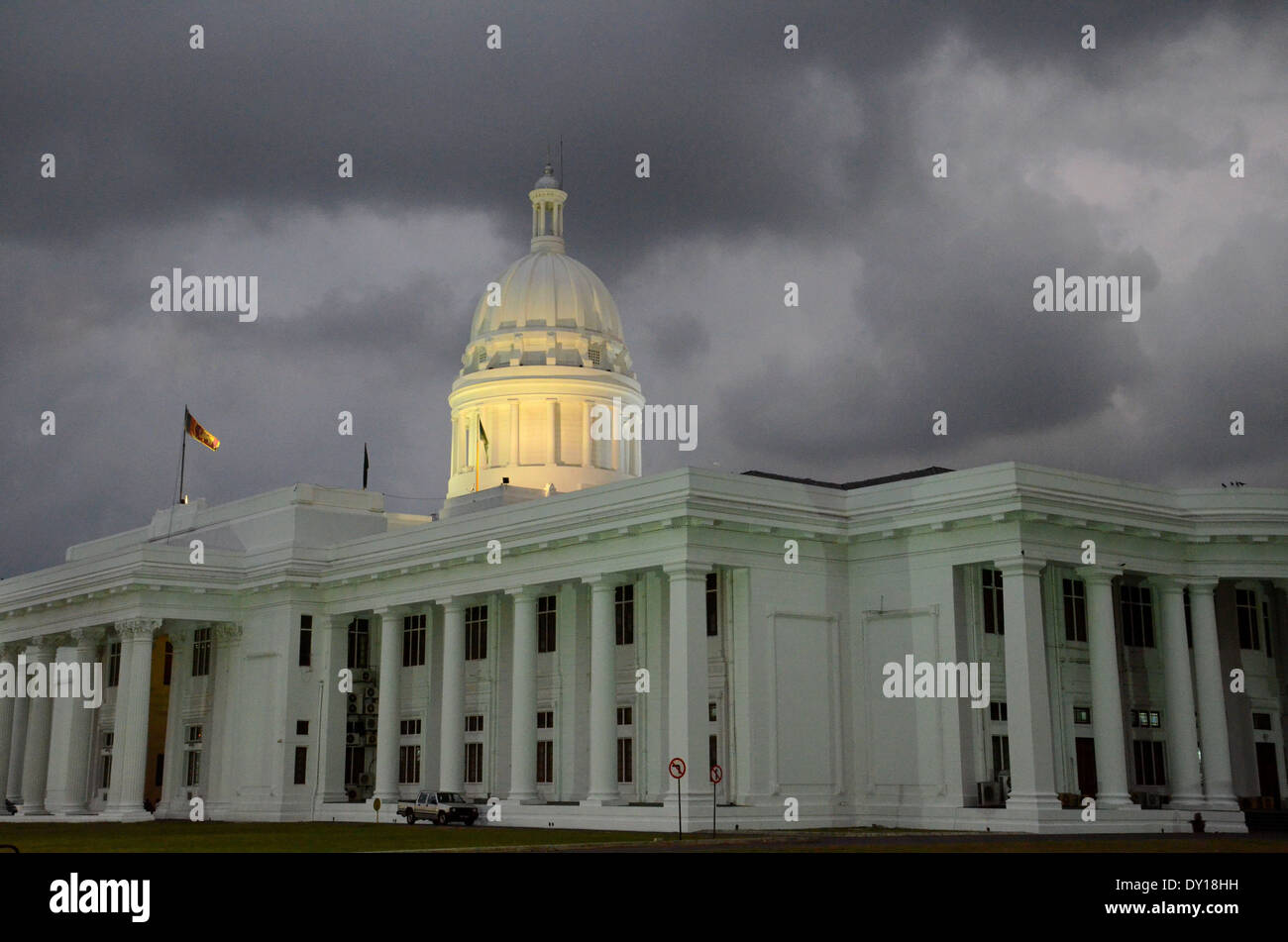 City Town Hall municipal building with dome and flag flying in evening ...