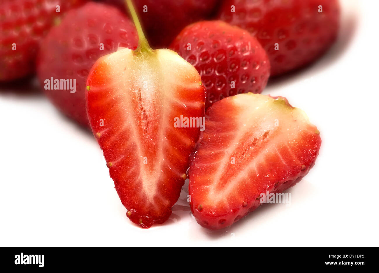 Fresh Strawberries one cut in half Stock Photo - Alamy