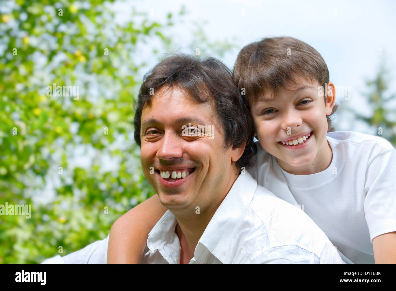 Portrait of young happy father getting busy with his son Stock Photo ...