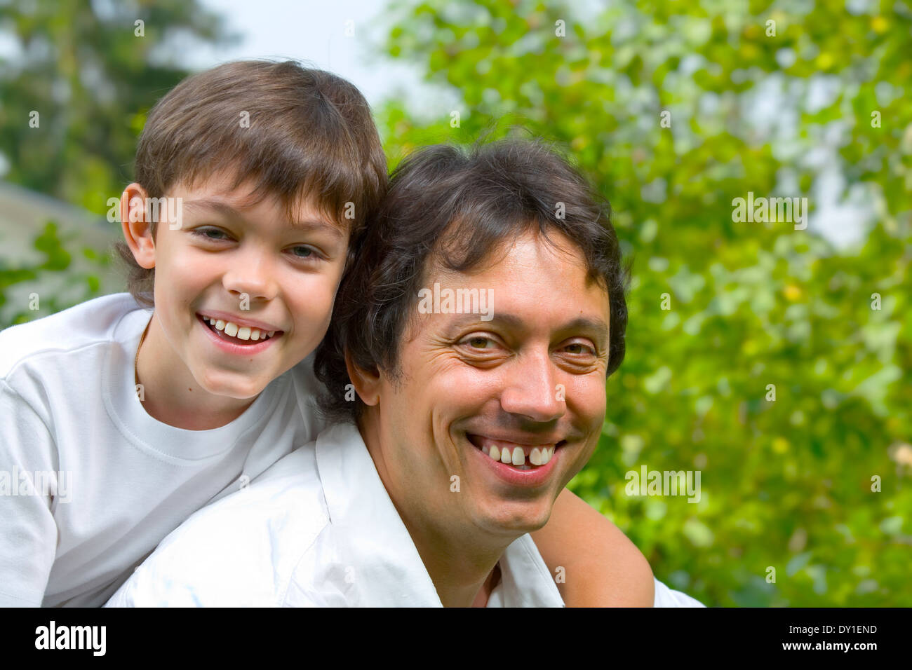 Portrait of young happy father getting busy with his son Stock Photo ...