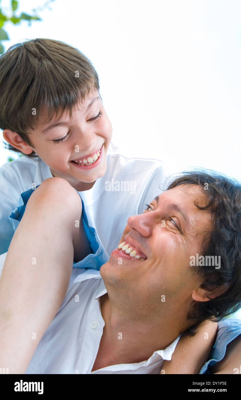 Portrait of young happy father getting busy with his son Stock Photo ...