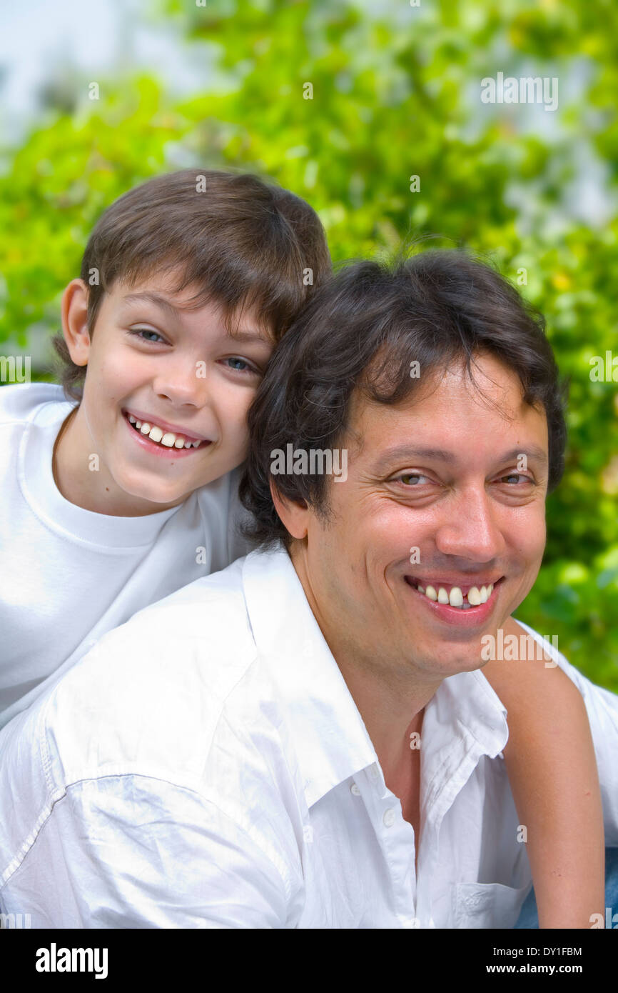 Portrait of young happy father getting busy with his son Stock Photo ...