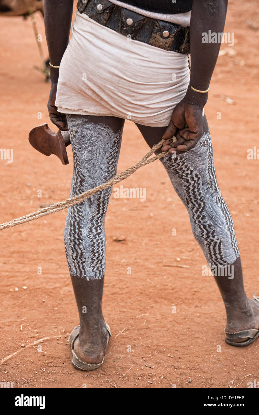 the painted legs of a Hamer man at the weekly market in Dimeka, Omo ...