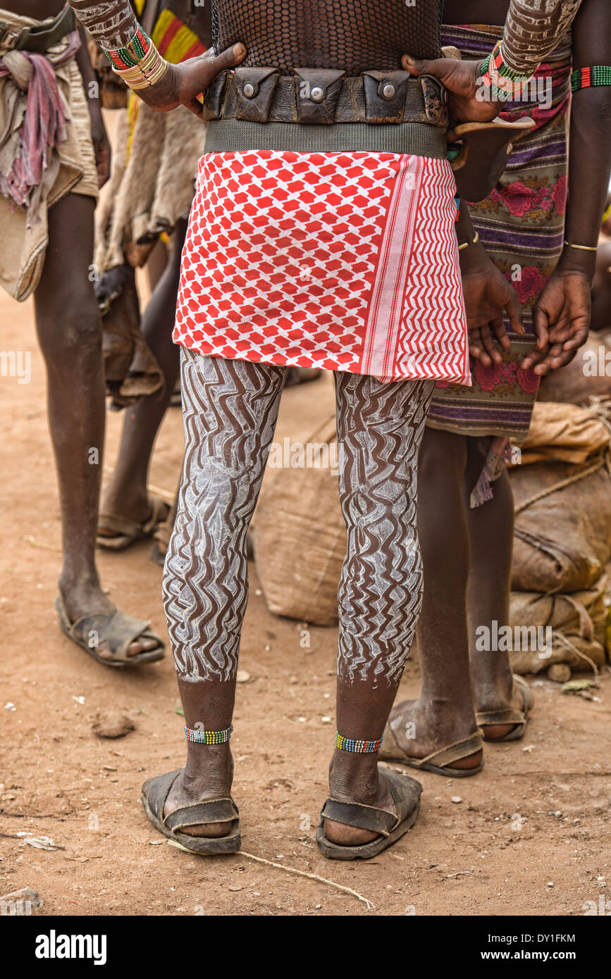 the painted legs of a Hamer man at the weekly market in Dimeka, Omo ...