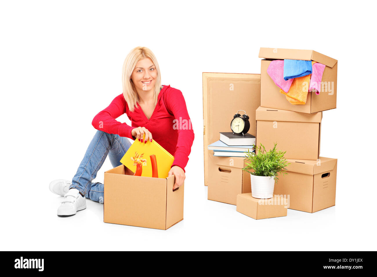Young girl sitting with moving boxes next to her Stock Photo - Alamy
