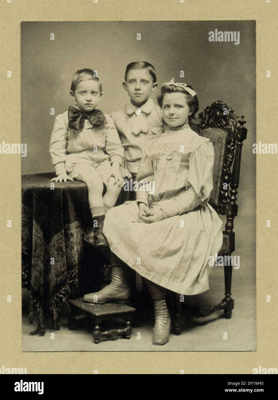 Ancient photograph of three children posing for the photographer in the ...