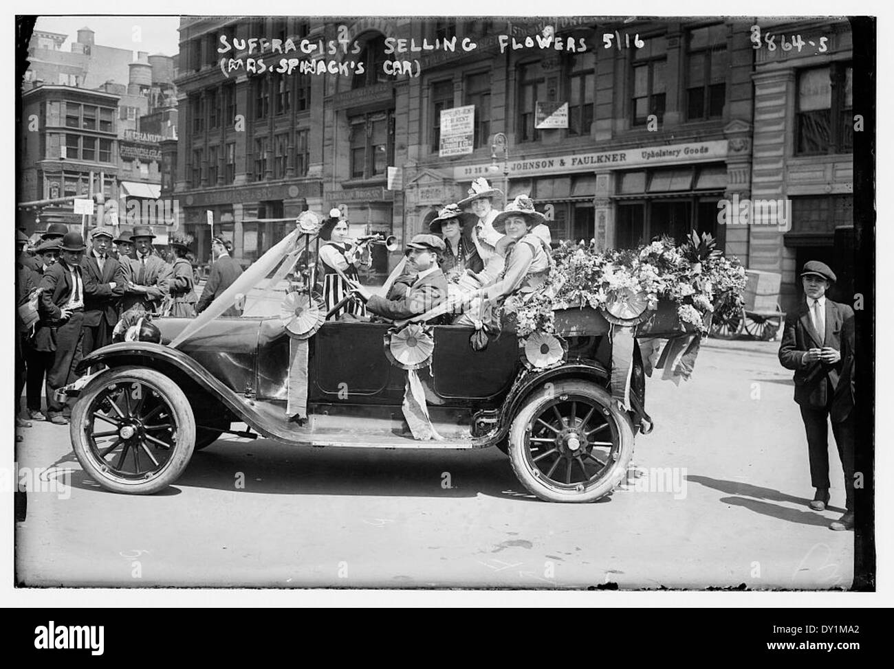 This historical photograph shows suffragists selling flowers from Mrs ...