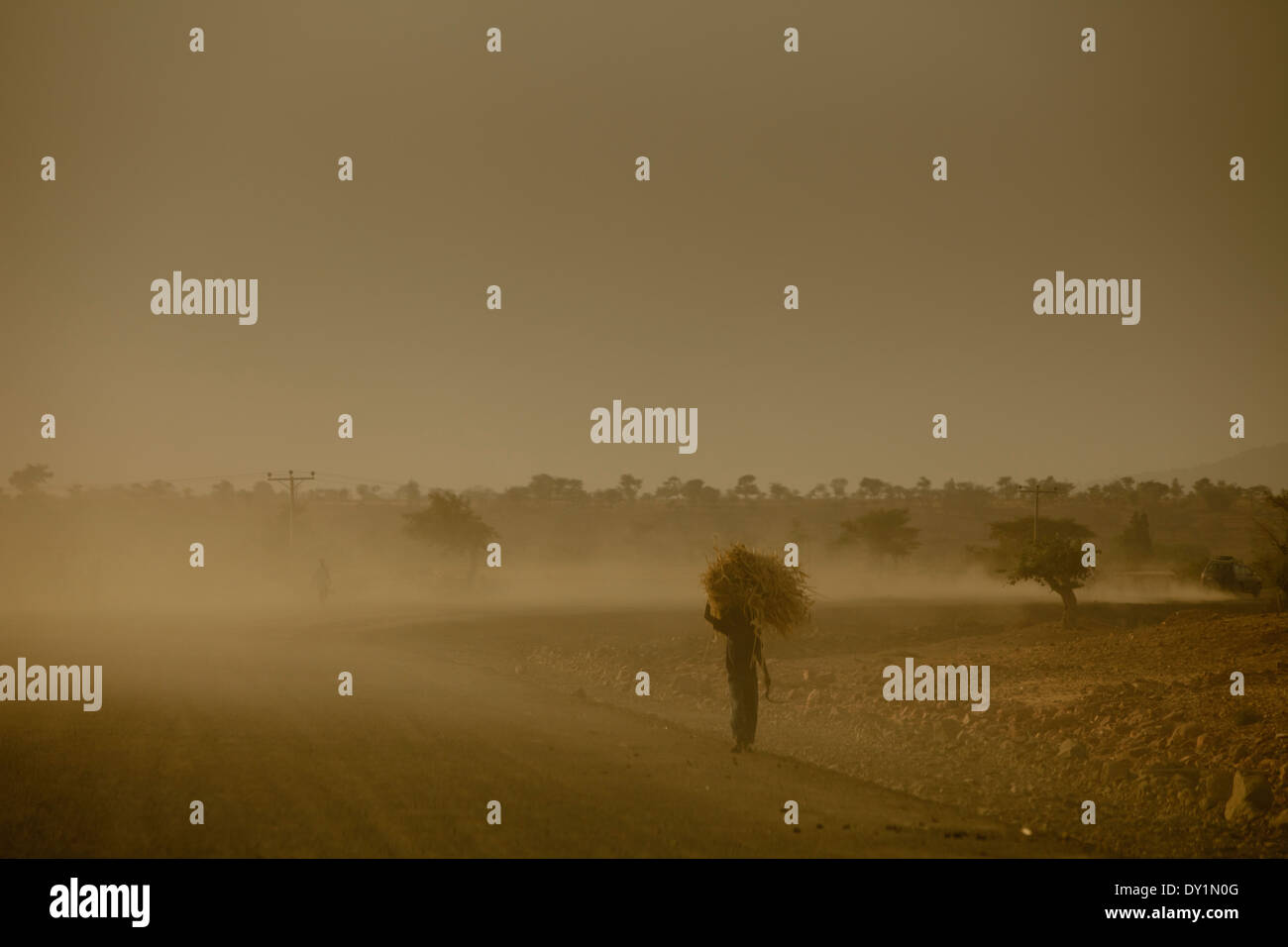 Man walking on dusty road hi-res stock photography and images - Alamy
