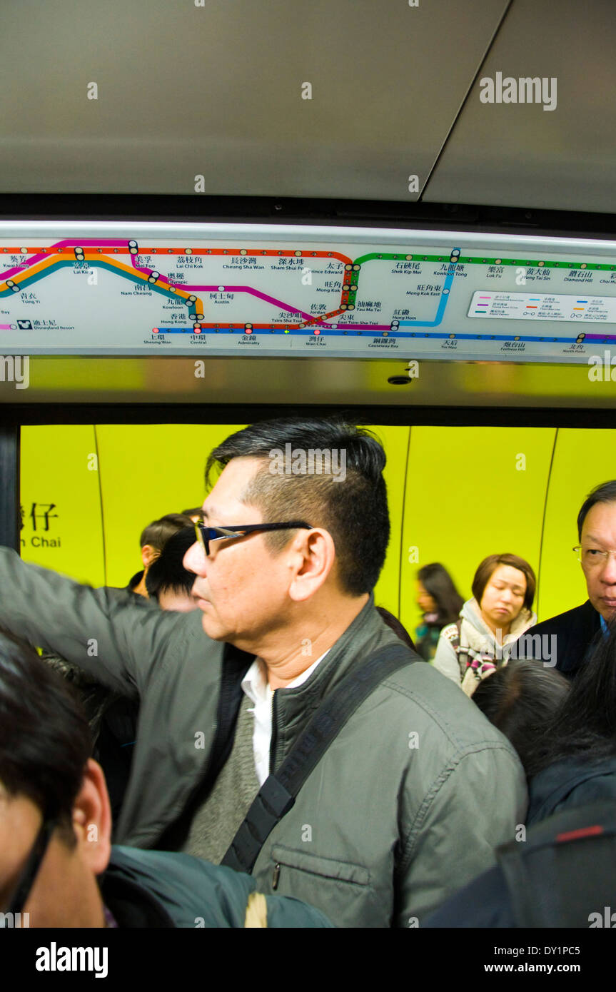 Passengers board a carriage on MTR metro subway train in Hong Kong ...
