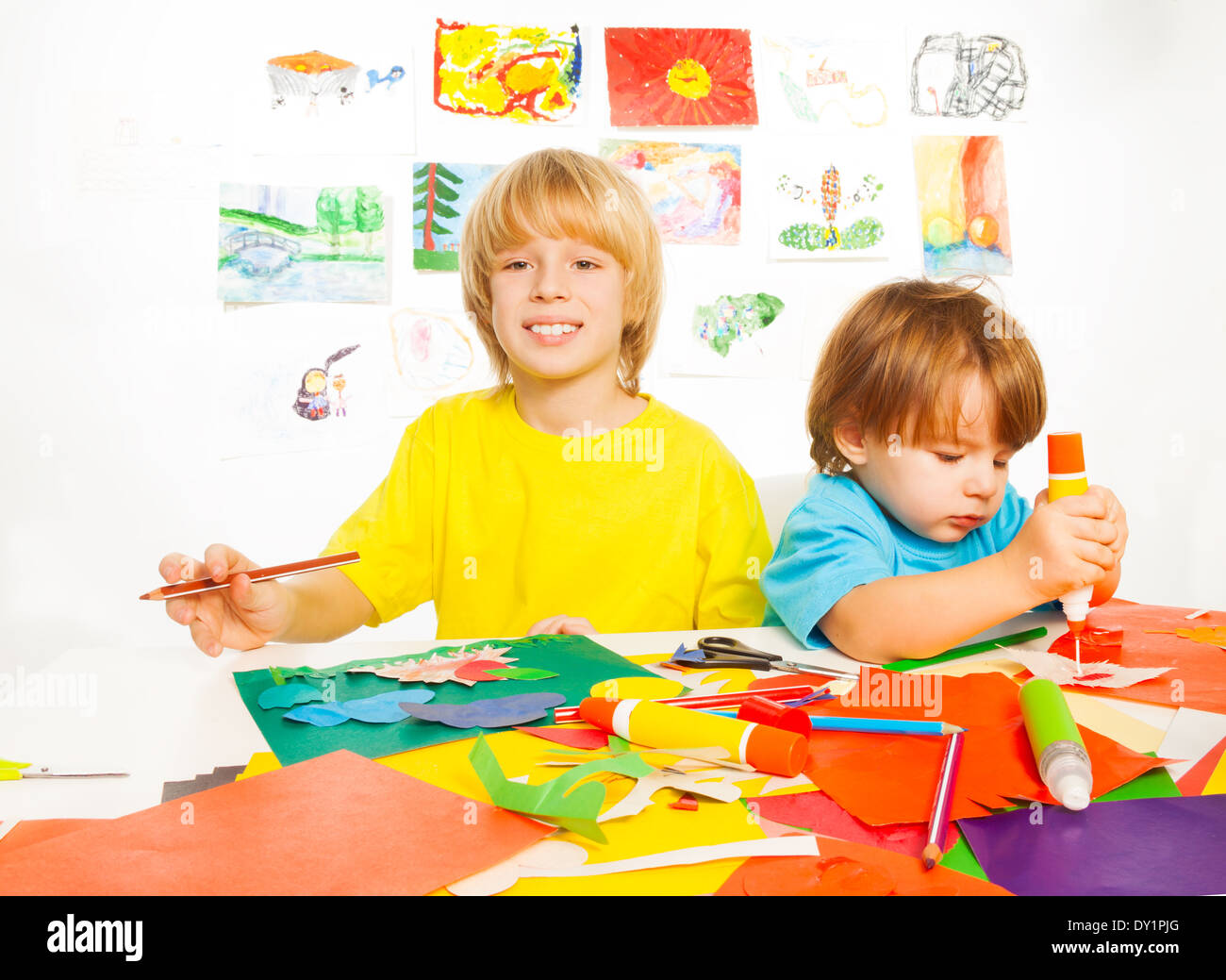 Boys cut draw and glue Stock Photo - Alamy
