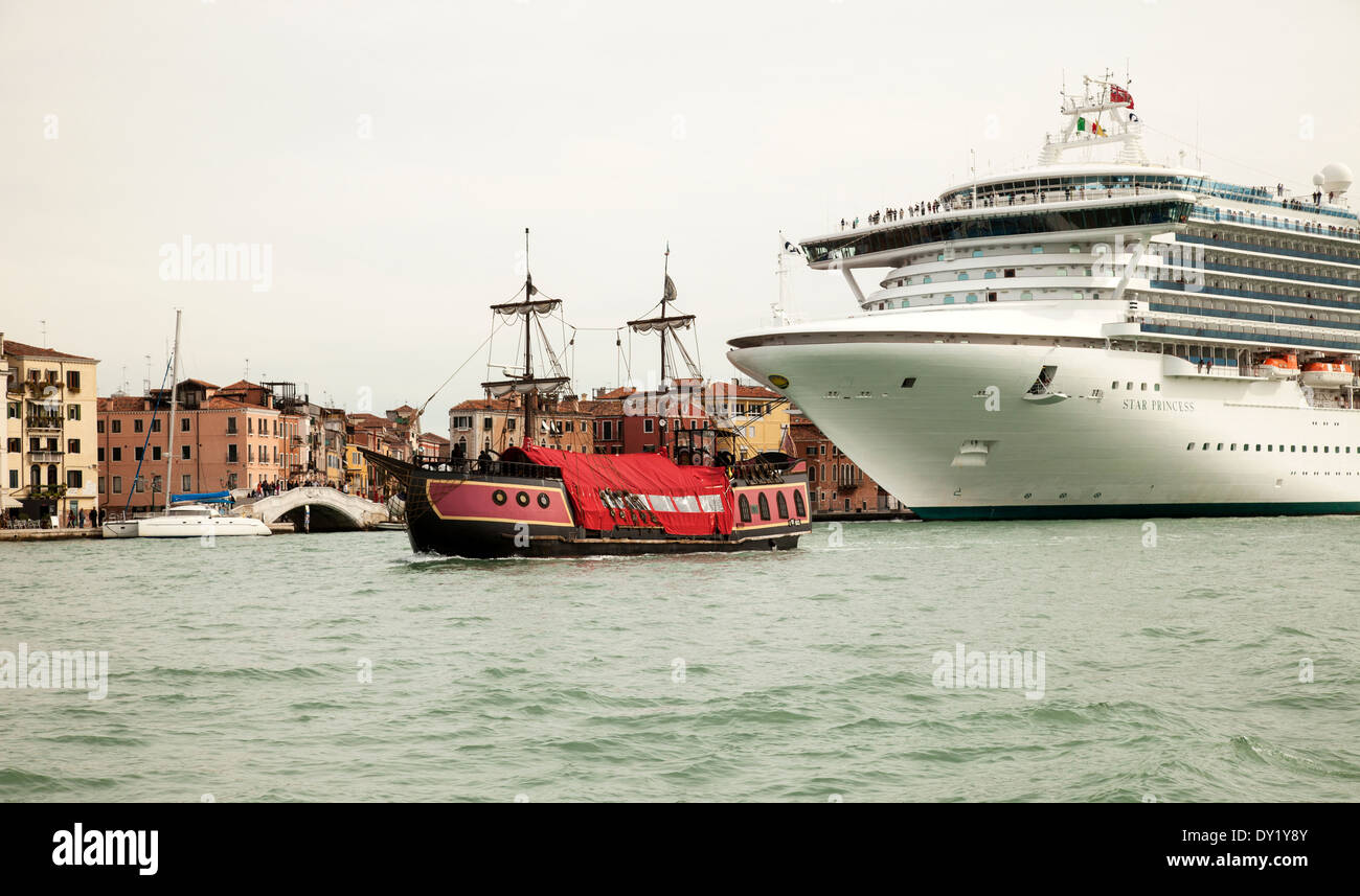 big cruise ship chasing old small ship,on the way to Murano, Italy ...
