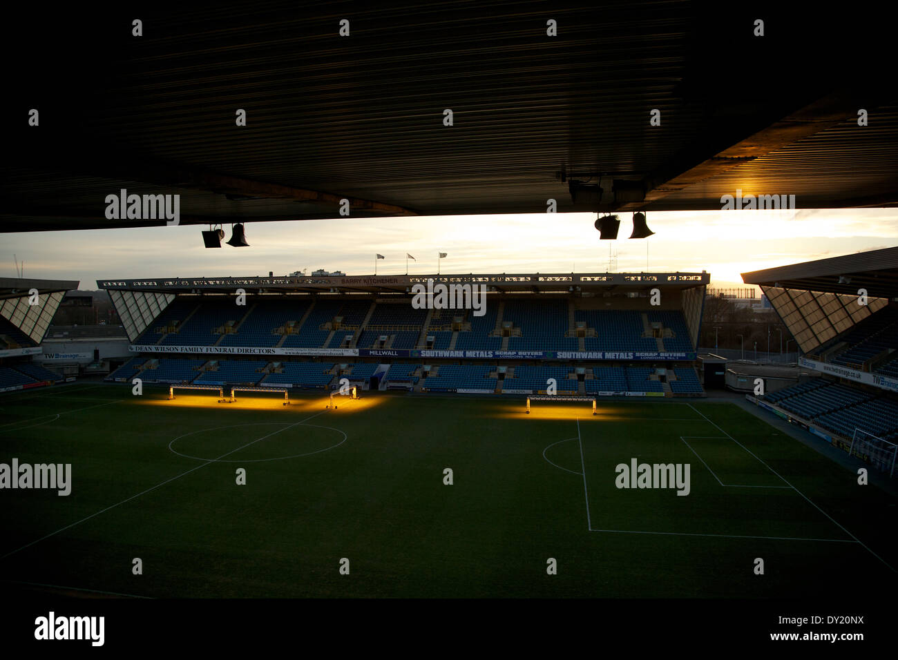 Interior view of Millwall Football Ground, the Den, and pitch at sunset ...