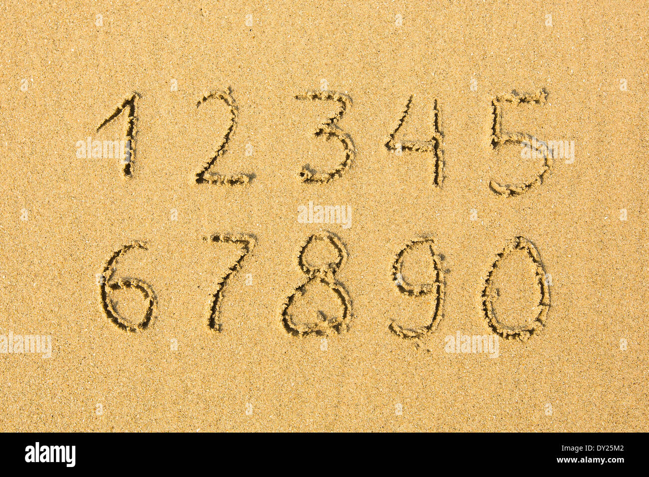 Numbers written on a sandy beach Stock Photo - Alamy