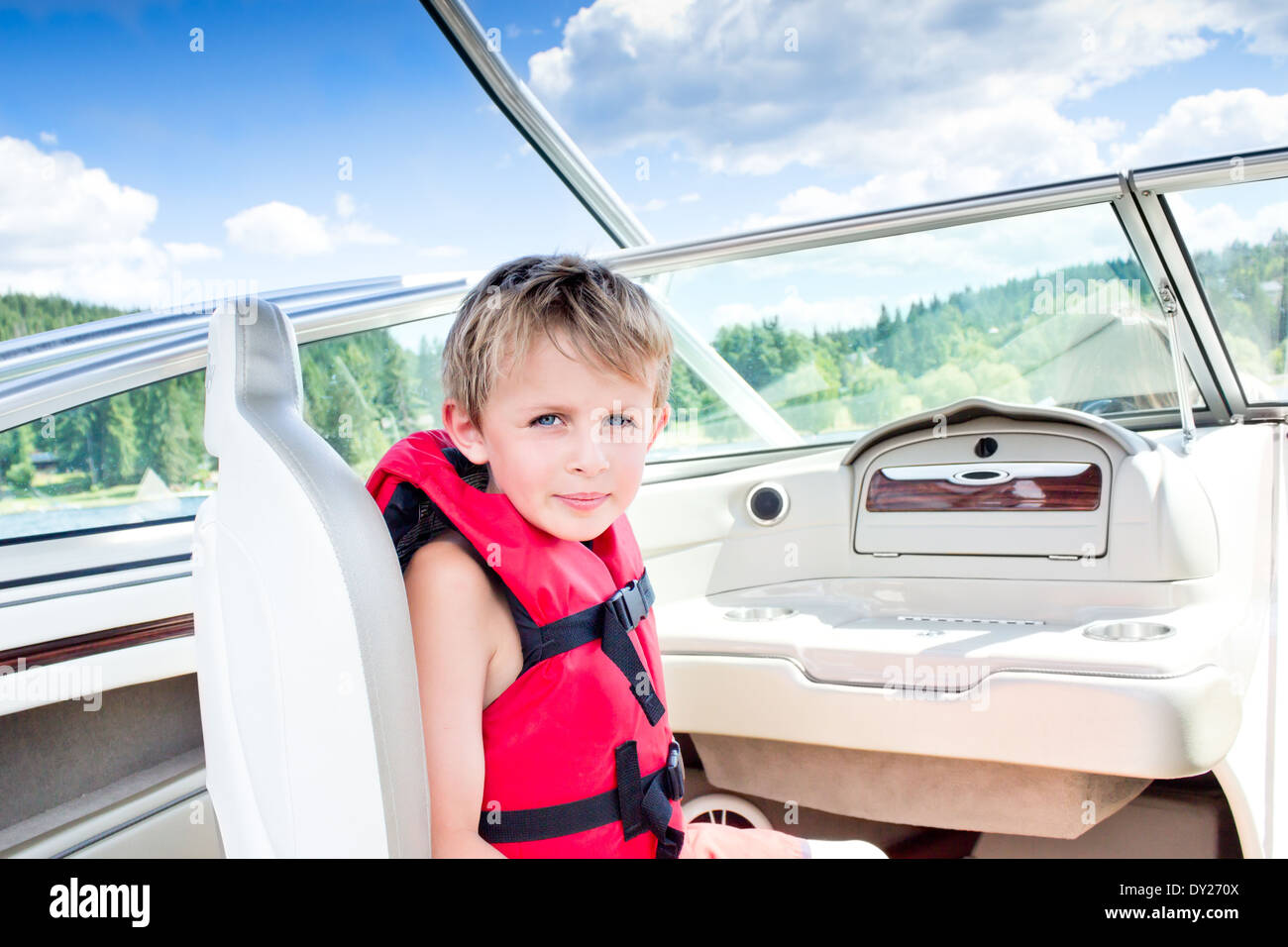 Young Boy sitting in the seat of a speedboat in summer Stock Photo - Alamy