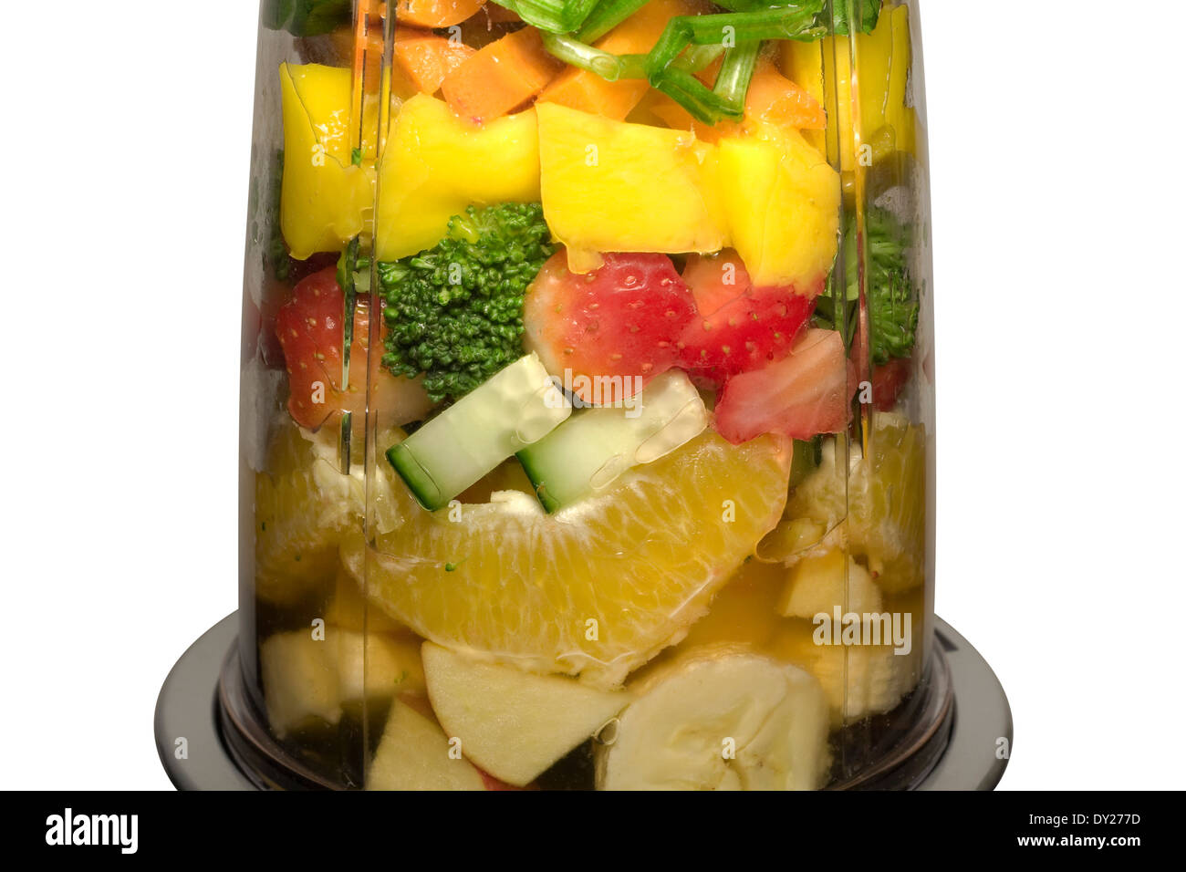 Cut Out. Various Fruits and Vegetables inside of a smoothie machine ...