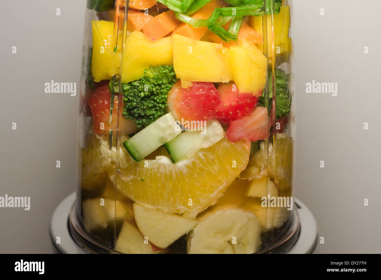 Various Fruits and Vegetables inside of a smoothie machine waiting to ...