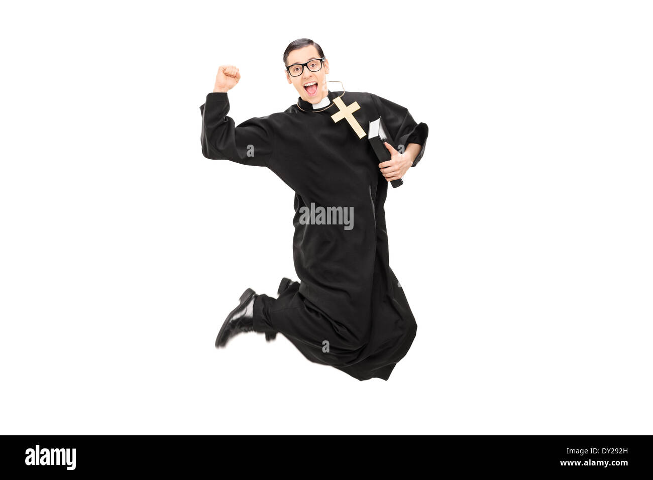 Excited male priest jumping with joy Stock Photo - Alamy