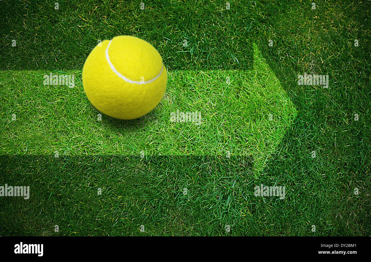 tennis ball on the grass with direction arrow Stock Photo - Alamy