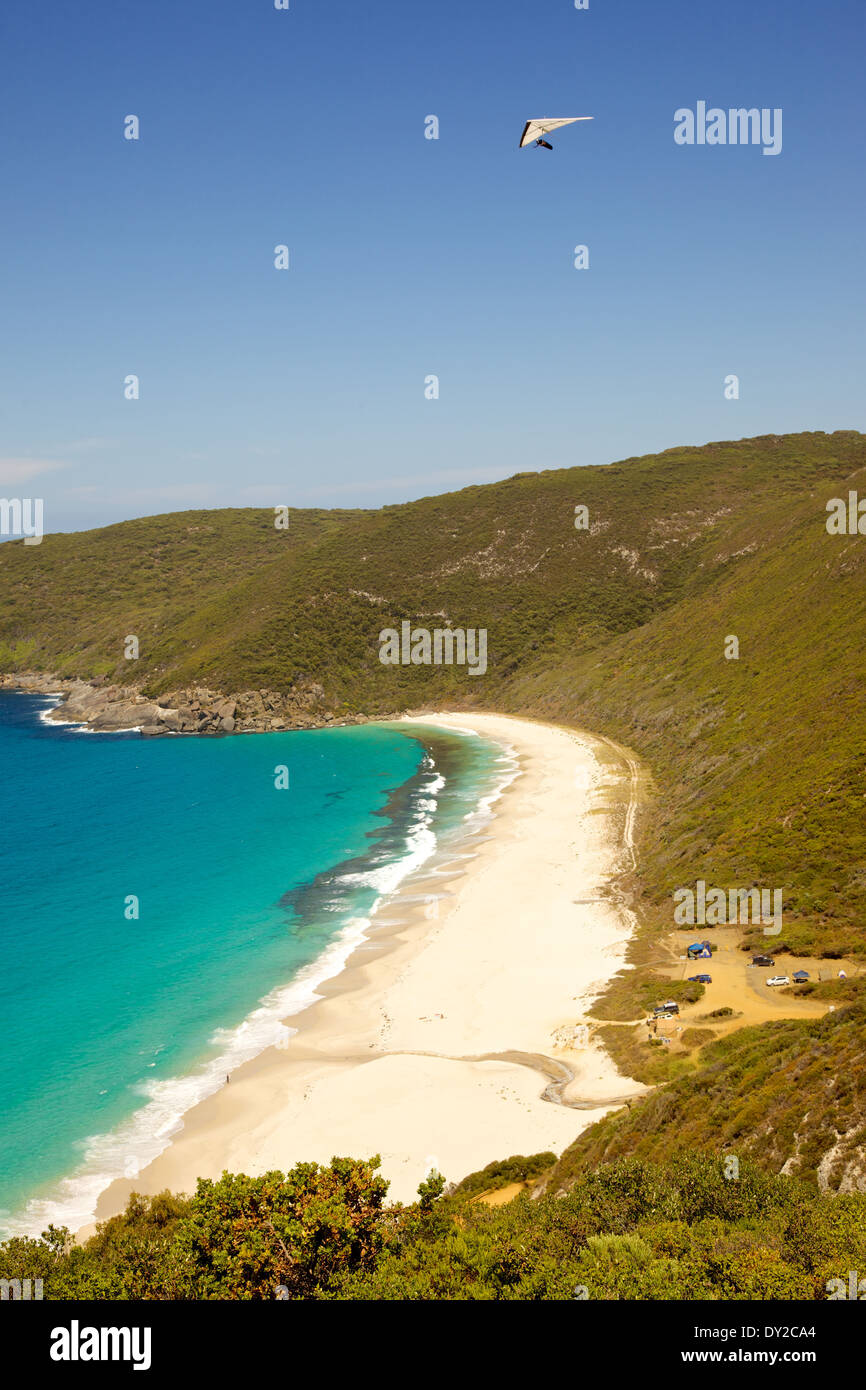 A hang glider flies over Shelley Beach in West Cape Howe National Park ...