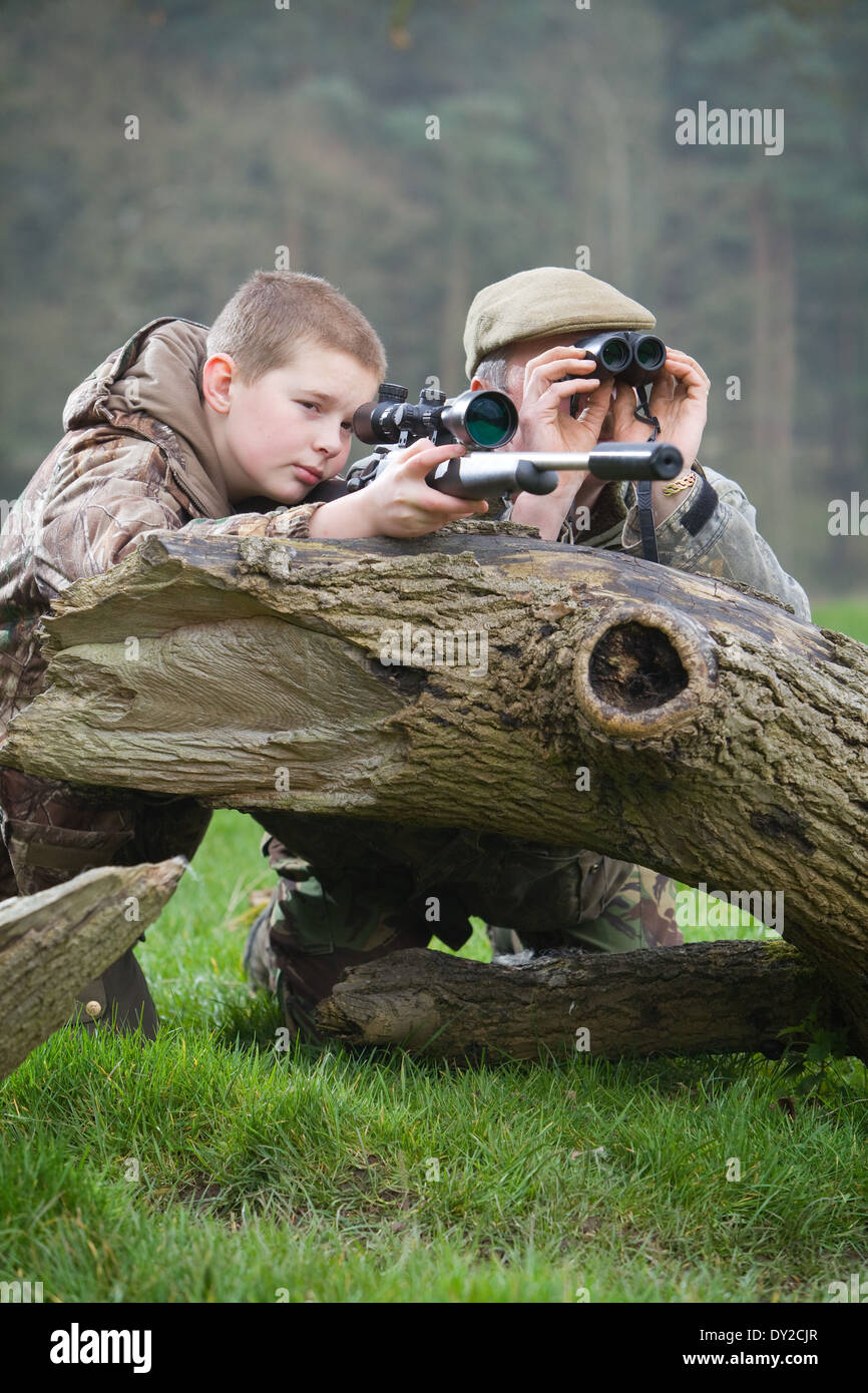 Father teaching son with rifle hi-res stock photography and images - Alamy