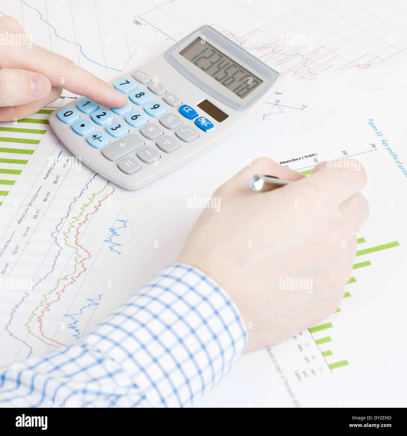 Business man busy doing some calculations at the desk Stock Photo - Alamy