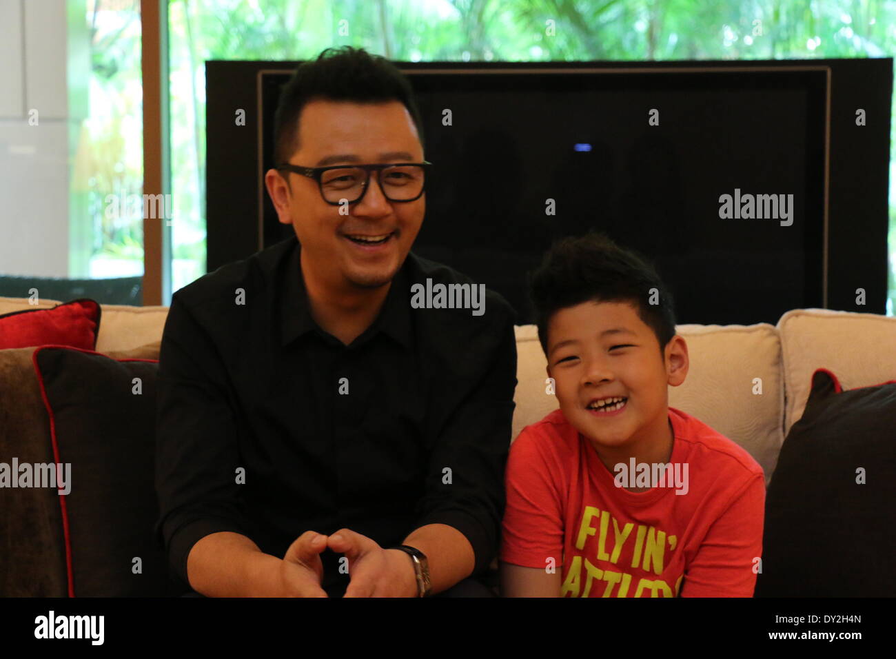 Singapore. 4th Apr, 2014. Chinese actor Guo Tao and his son take an ...