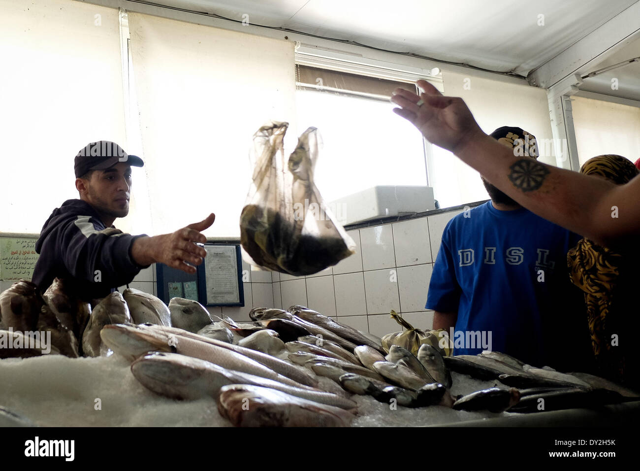 Tripoli, Libya. 4th Apr, 2014. Citizens buy fishes at a seafood market ...