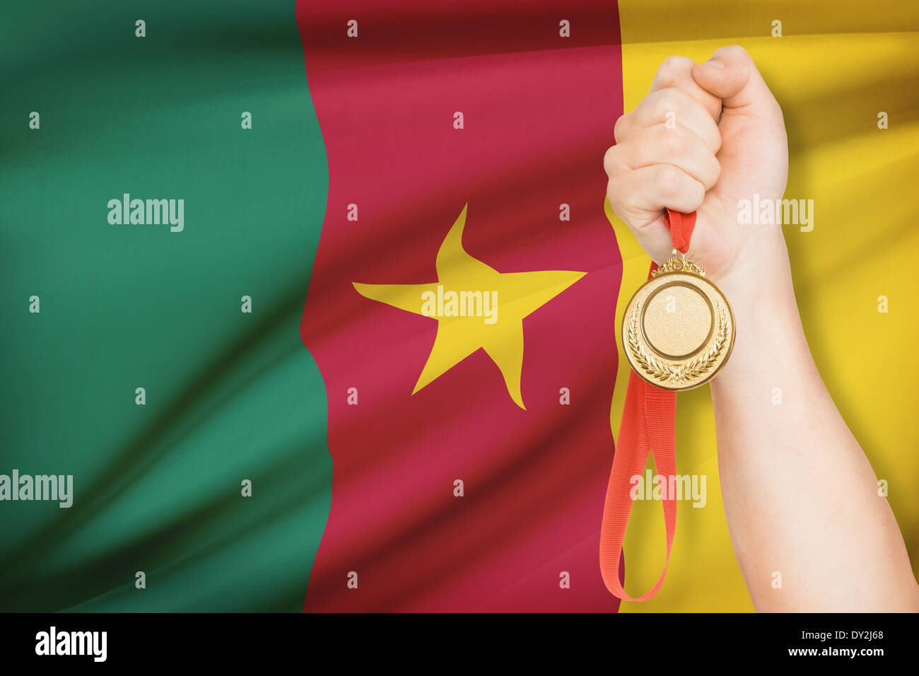 Sportsman holding gold medal with flag on background - Republic of ...