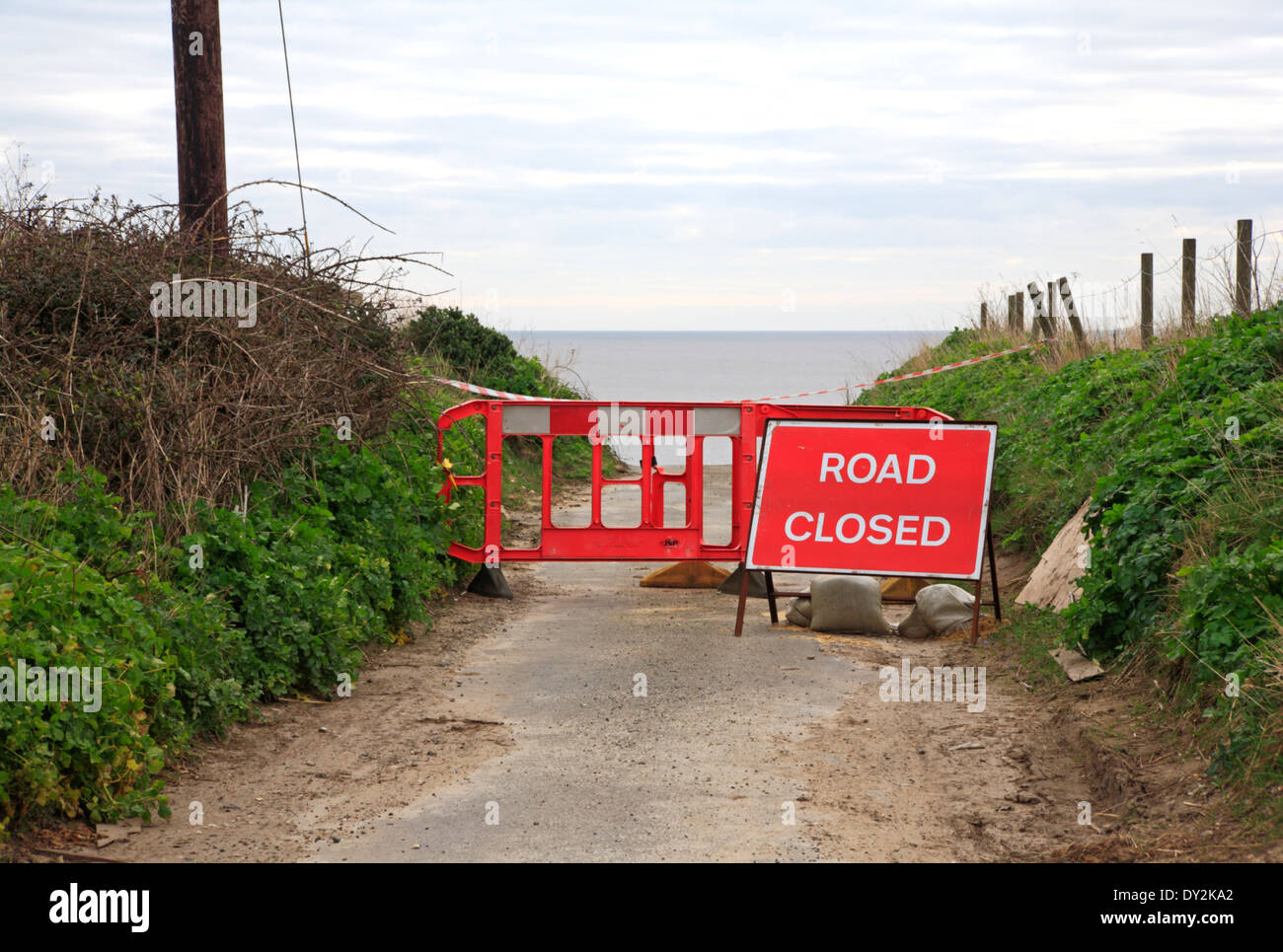 A view of a coast road terminating at an eroding cliff edge at ...