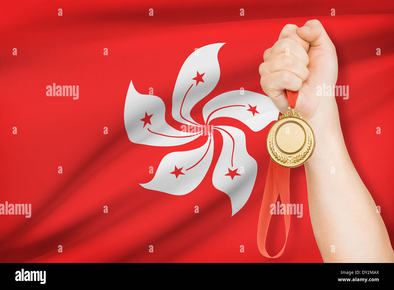 Sportsman holding gold medal with flag on background - Hong Kong ...