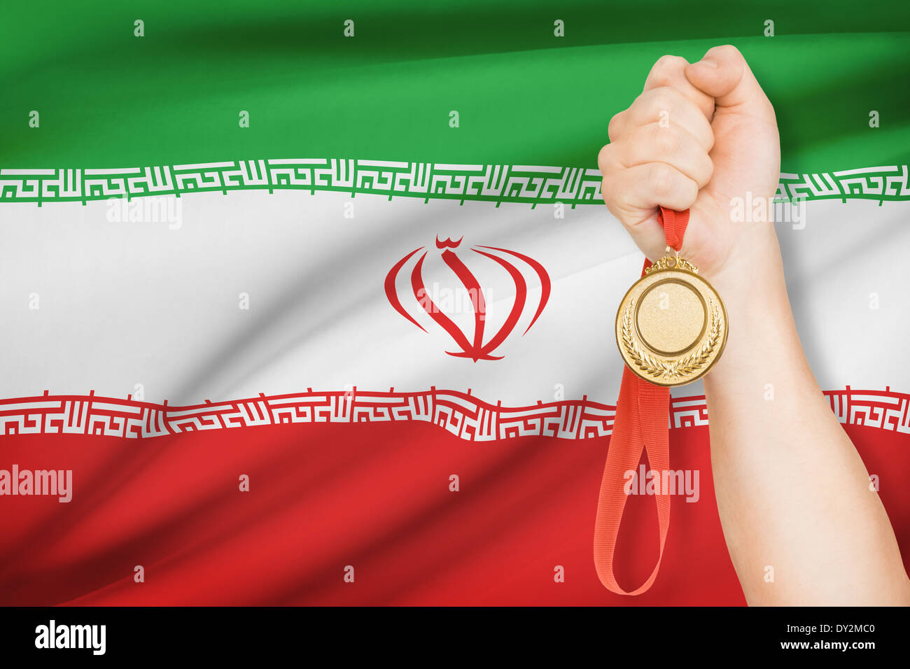 Sportsman holding gold medal with flag on background - Islamic Republic ...