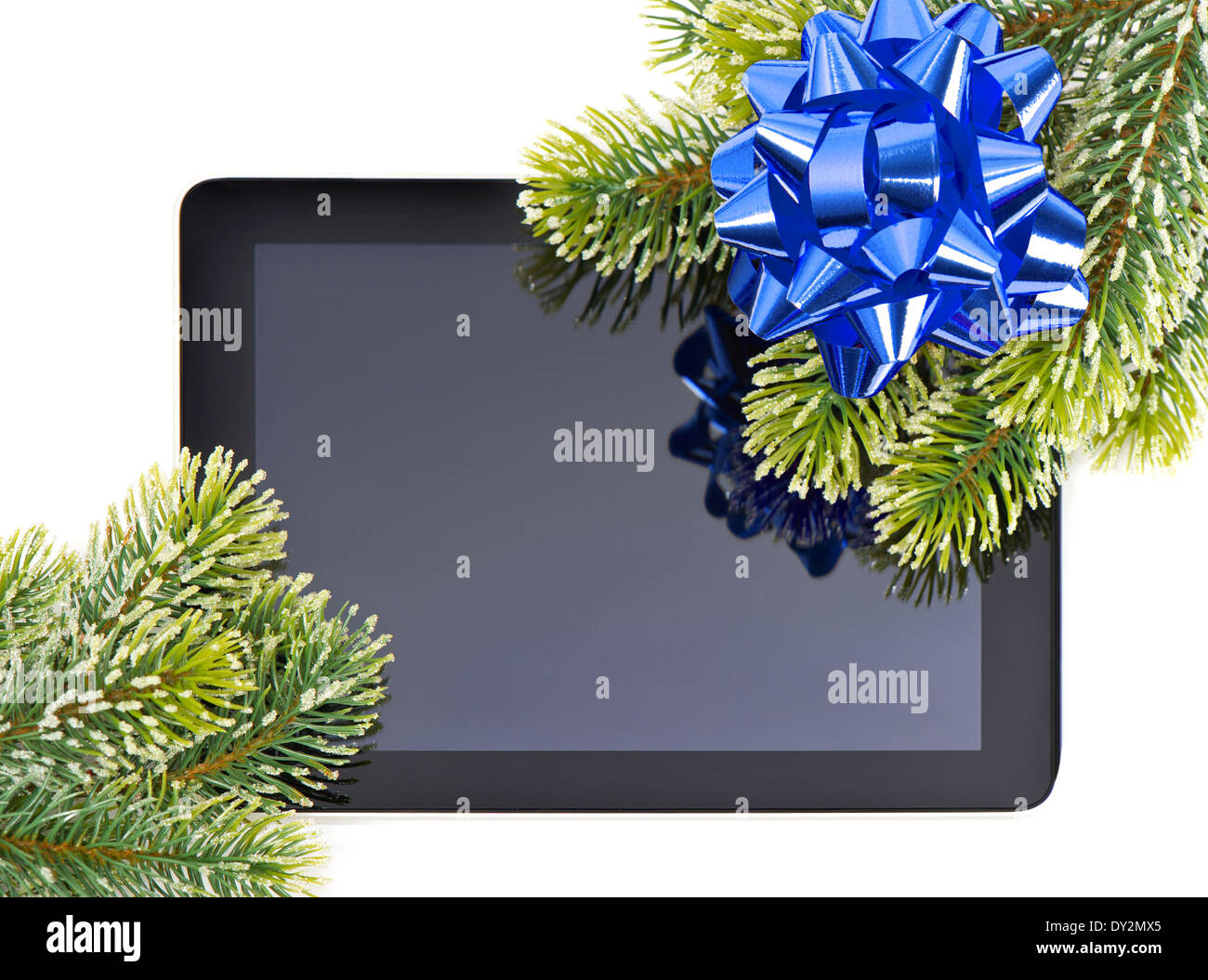 tablet pc with tree branch and blue shiny bow decoration. gift concept ...