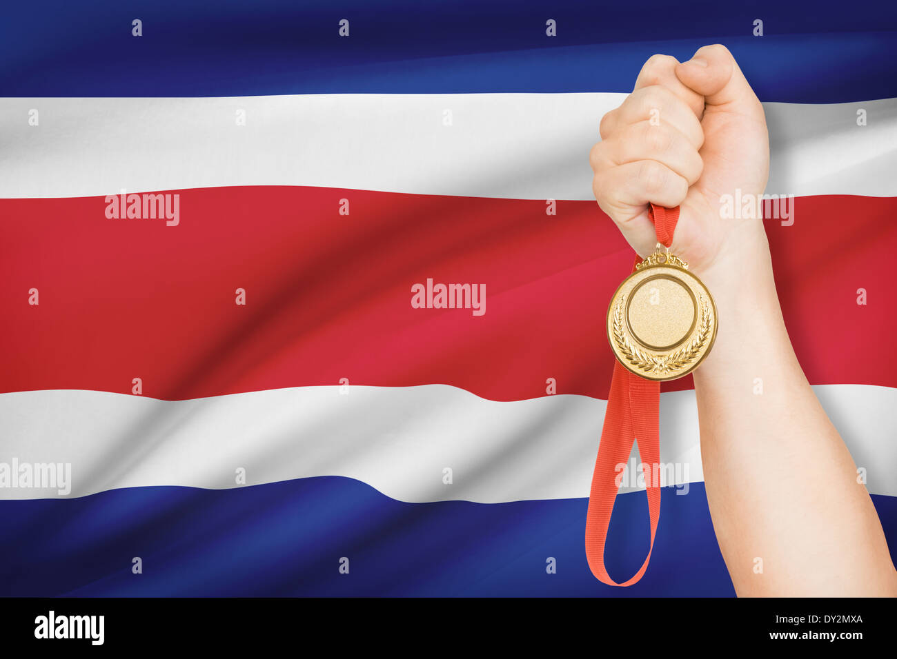 Sportsman holding gold medal with flag on background - Republic of ...